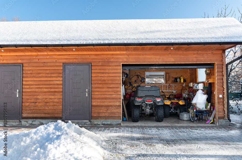Facade view open door ATV home garage with quad bikes offroad vehicle ...