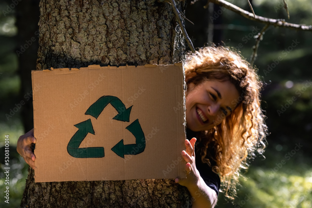 Symbol of recycling on a cardboards background.Girl holding a cardboard ...