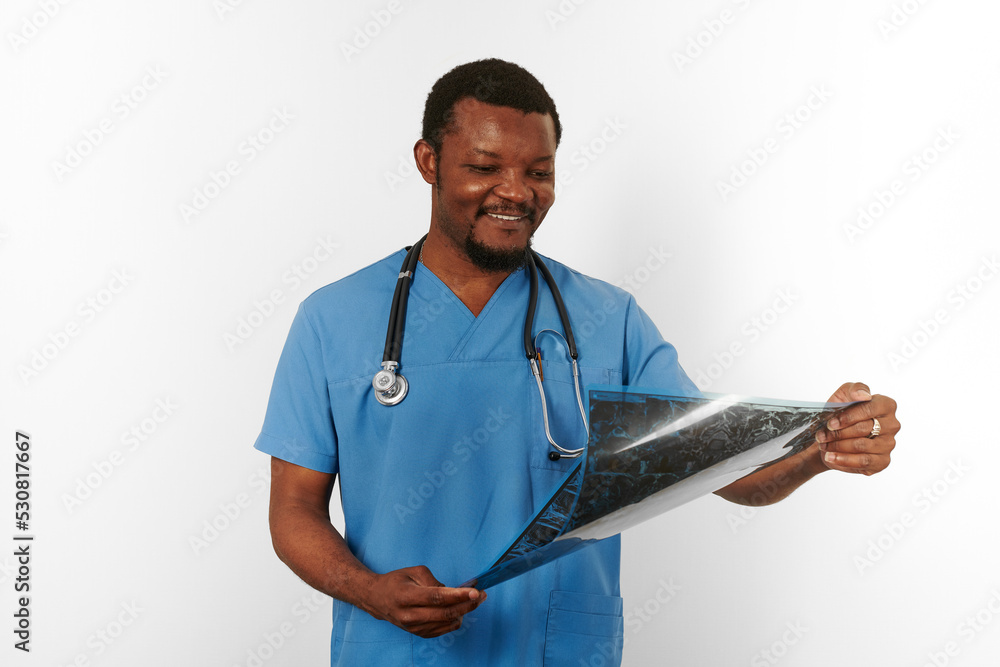 Smiling black surgeon doctor bearded man in blue coat with stethoscope ...