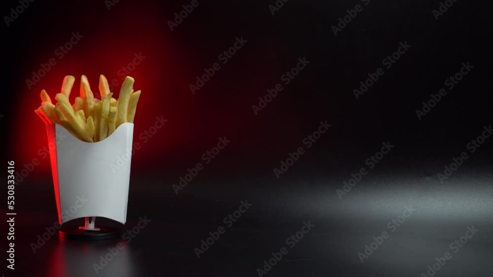 White paper packaging made of cardboard. French fries, fried, in a ...