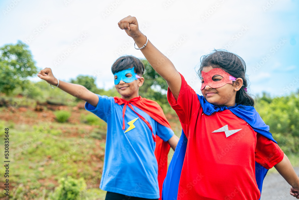 excited happy teenager kids in super hero costume on empty road with ...