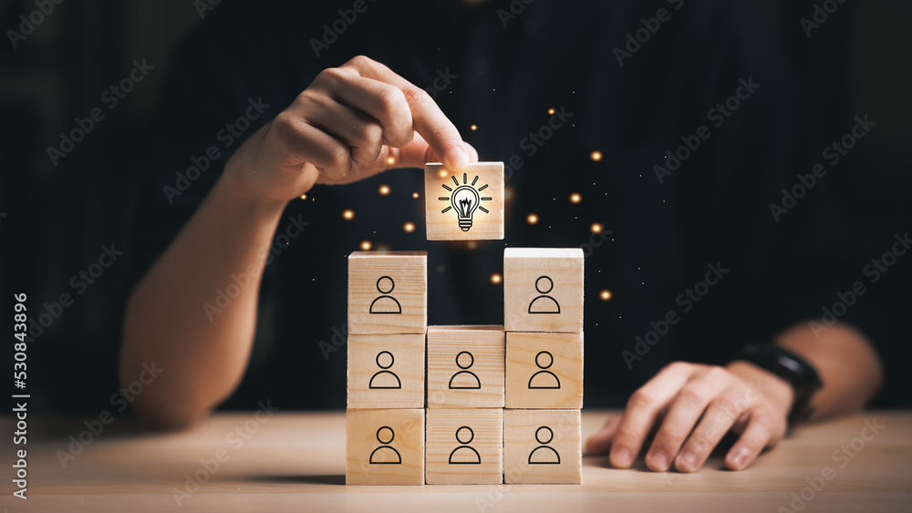 brainstorming creative idea and innovation. Hand putting over wooden ...