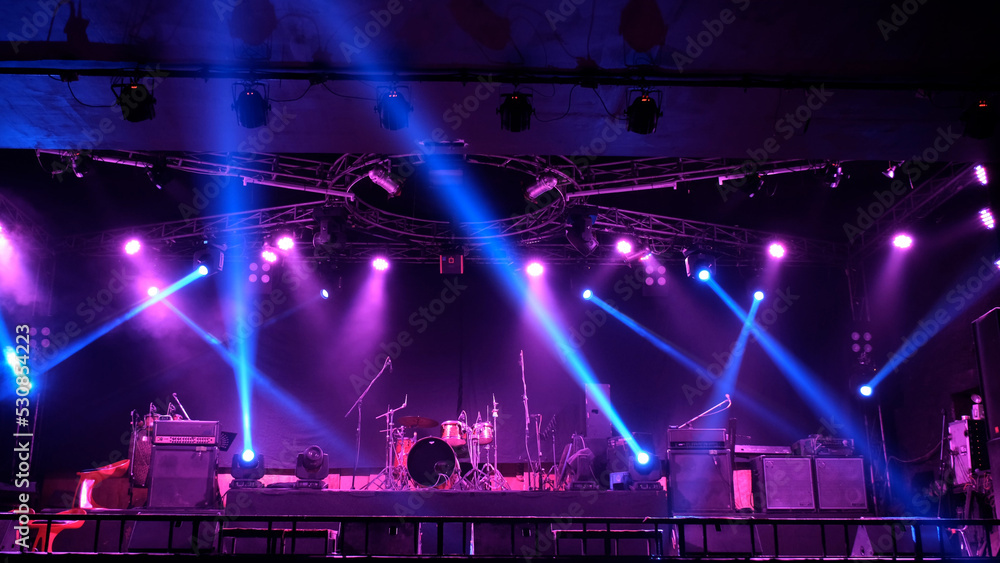 Stage lighting beams spotlight and smoke of events show or concerts ...