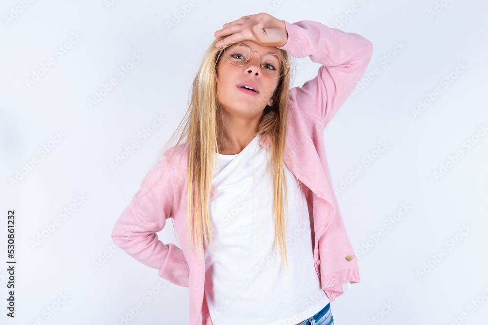 caucasian blonde little girl wearing pink jacket and glasses over ...