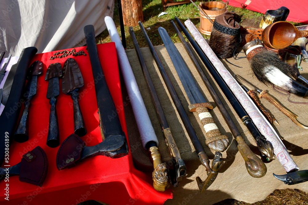 A close up on a set of medieval weaponry with weapons including axes ...