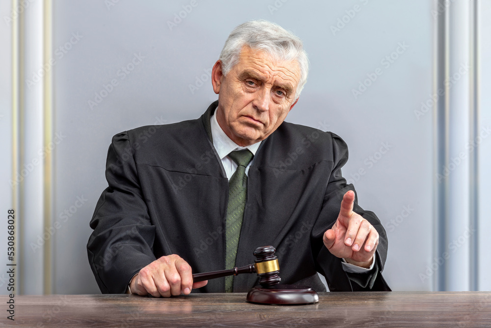 Judge banging judge's gavel, index finger pointing. Law Lord wearing ...