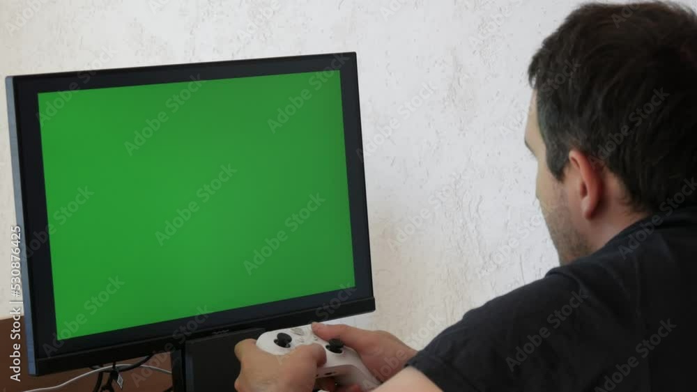 Young male gamer playing game console using joystick remote control ...