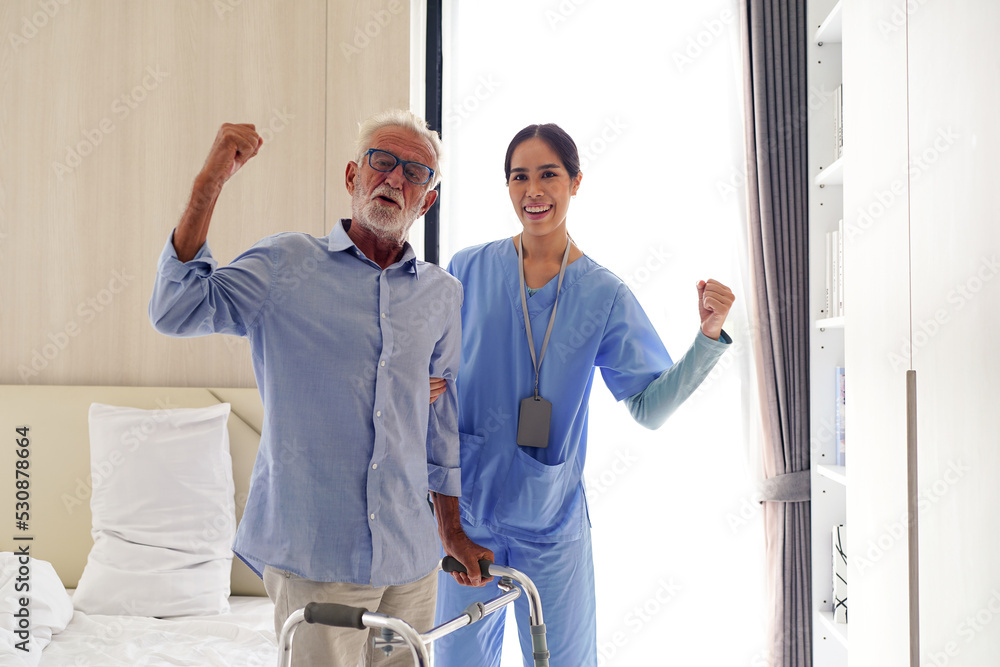 Smiling nurse assisting senior man to get up from bed. nurse in uniform ...
