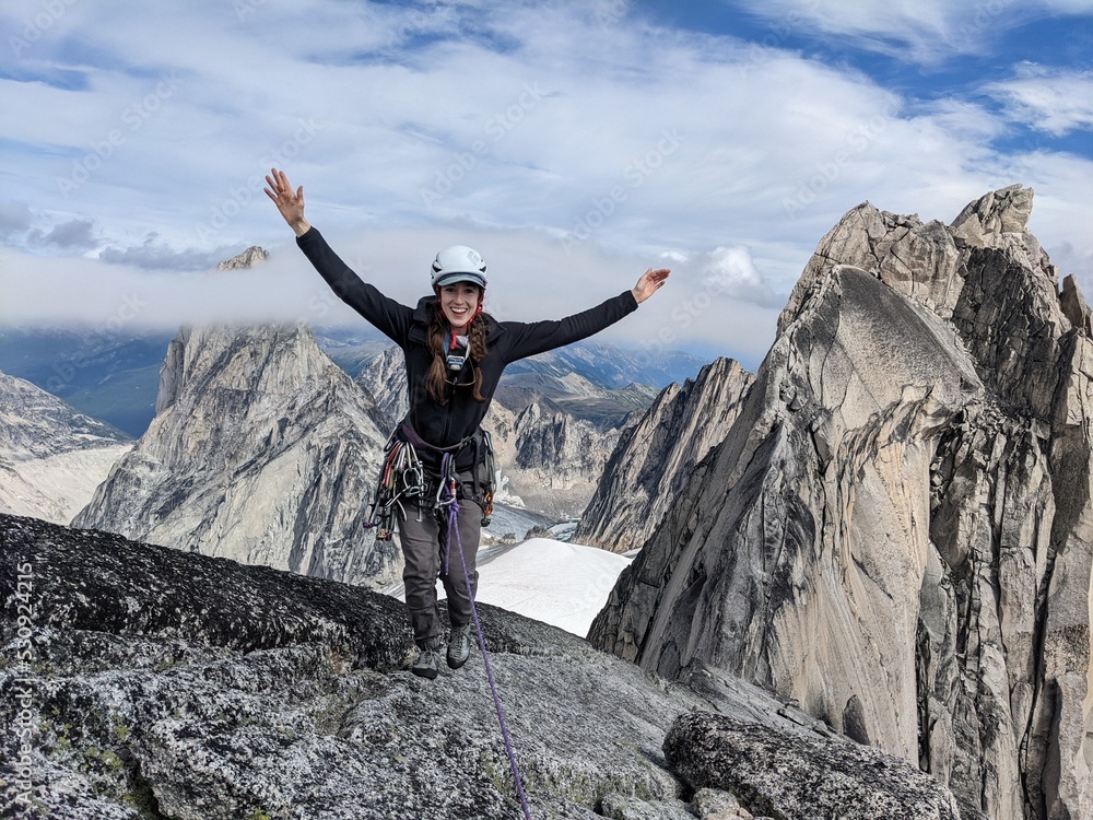 Female Climber Smiling on Summit of Rock Spire Stock Photo | Adobe Stock