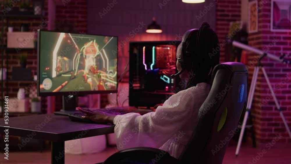 Over shoulder view of woman streaming first person shooter doing ...