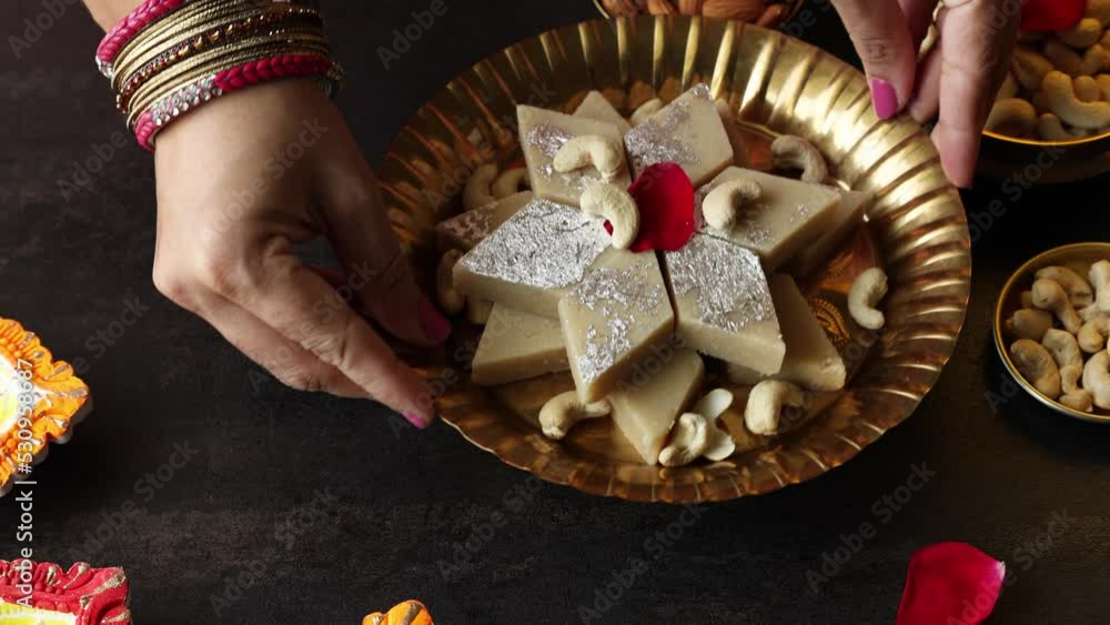 Kaju Katli Kaju Barfi Burfi cashew fudge candy woman hand serving ...