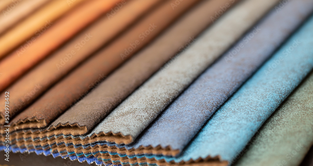 Fabric swatches in different colors are stacked for selection. A ...