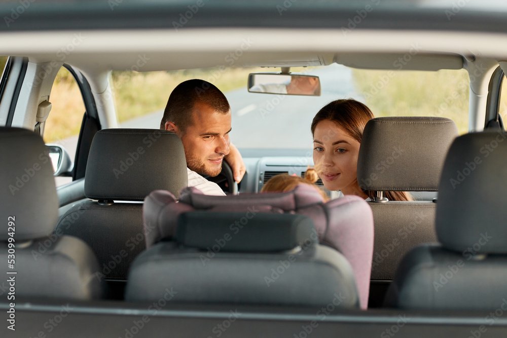 Image of young adult man and woman with little child driving in car ...
