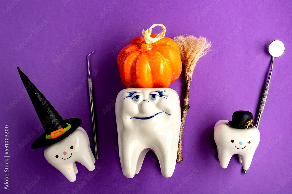 dental concept. figurines of teeth in halloween costumes and dental ...