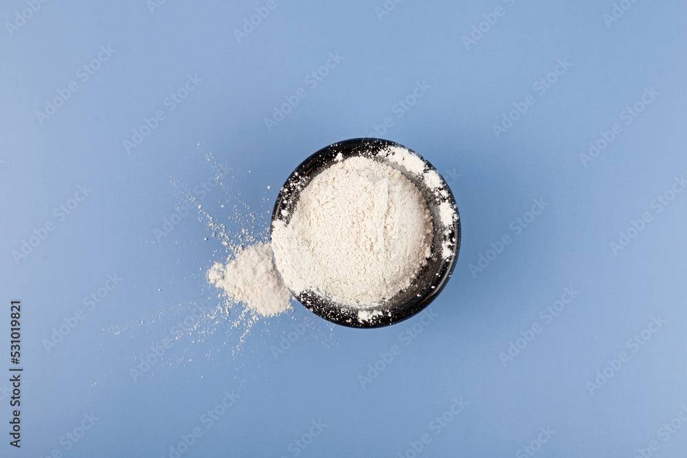 Titanium dioxide powder in black bowl. TiO2 also known as titanium (IV ...