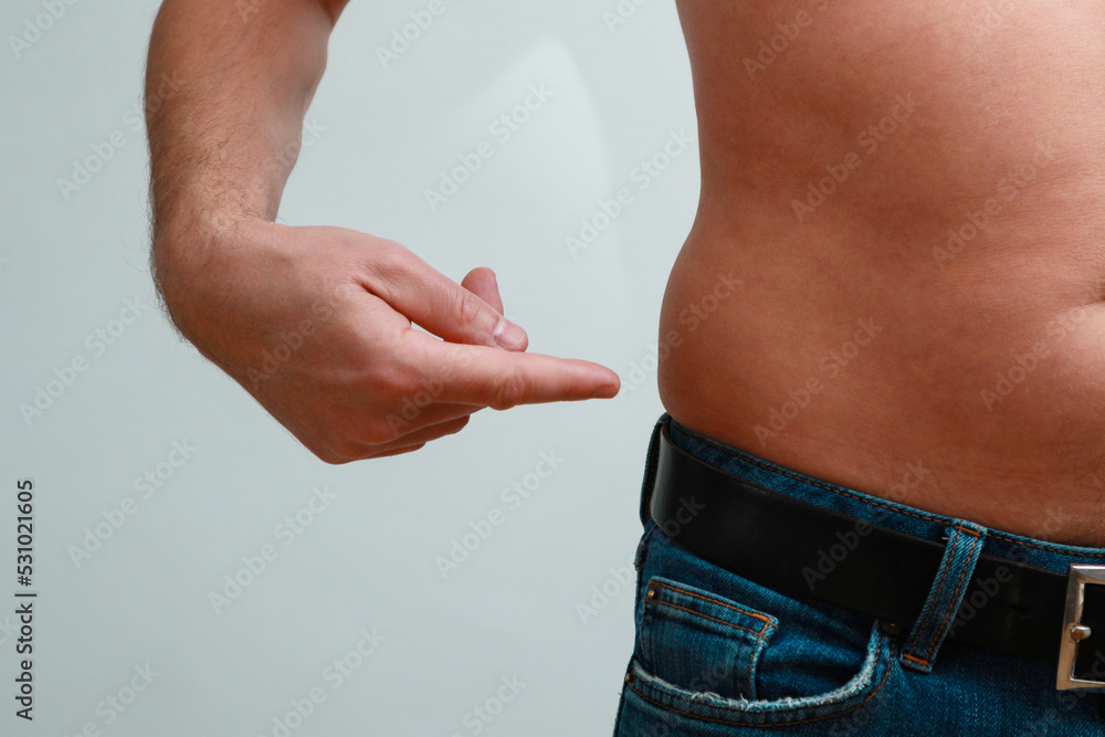 Foto de Man holding his excess fat around his waist. Pinch belly side ...