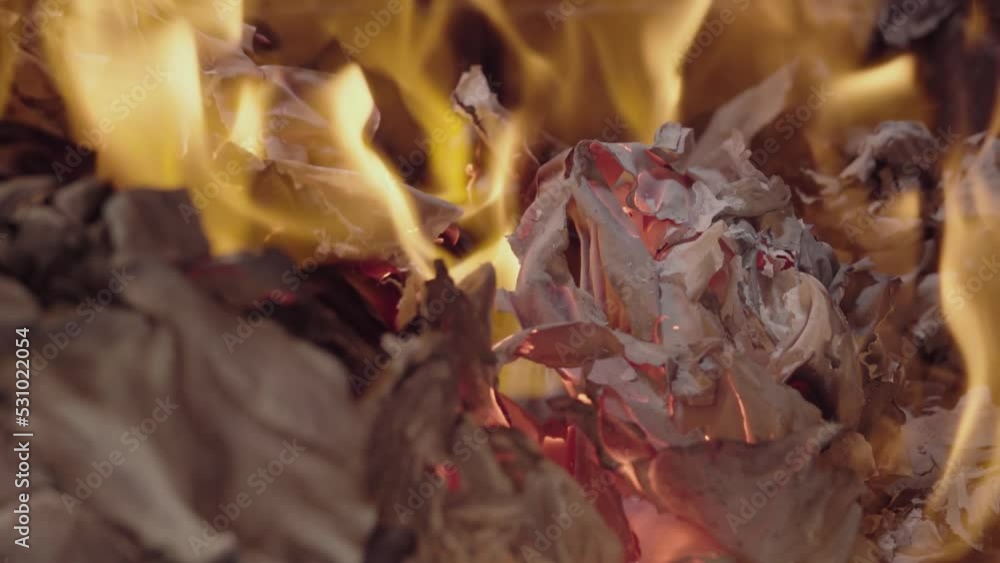 Remains of paper, newspaper or pages book on fire. Big bright flame ...