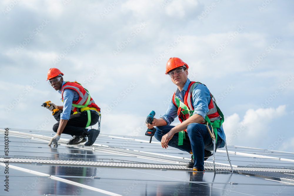 Technician wearing safety harness belt during installing the solar ...