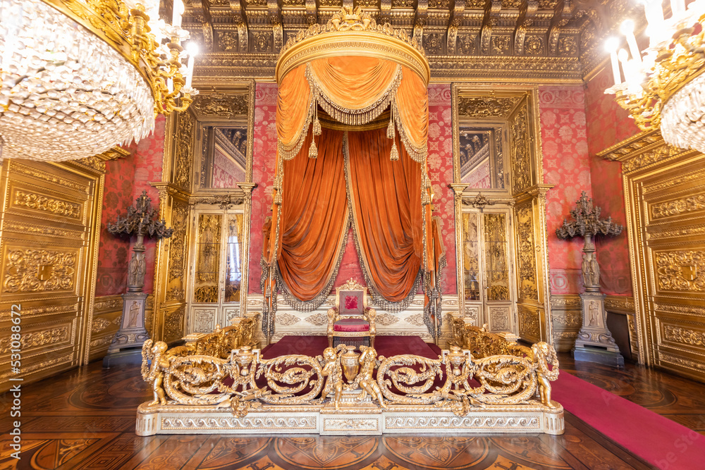 Old throne room interior with chair in luxury palace. Red and gold ...