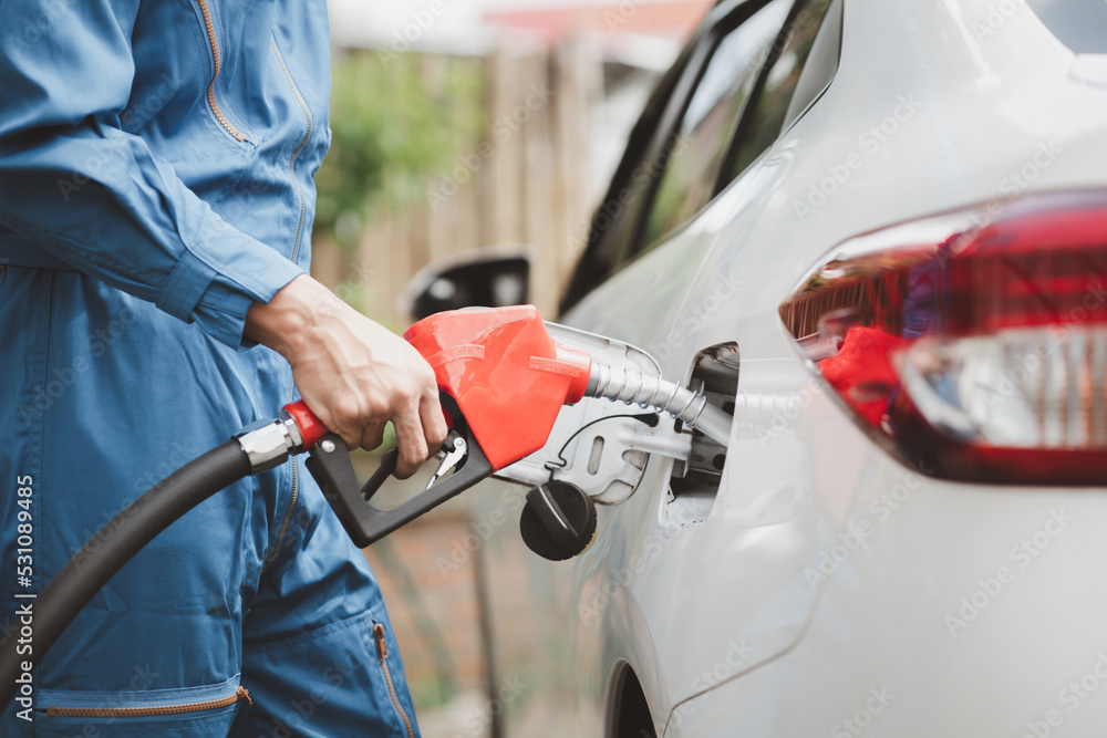 Gas station workers are refueling cars, fuel consumption, gasoline ...