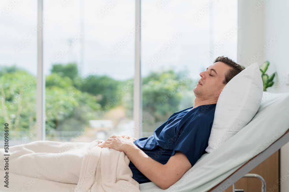 Young caucasian patient lying in bed feeling unhappy and depressed in ...
