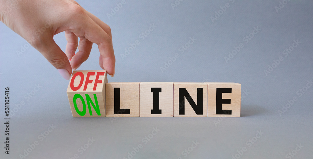 Offline and online symbol. Businessman hand turnes wooden cubes and ...