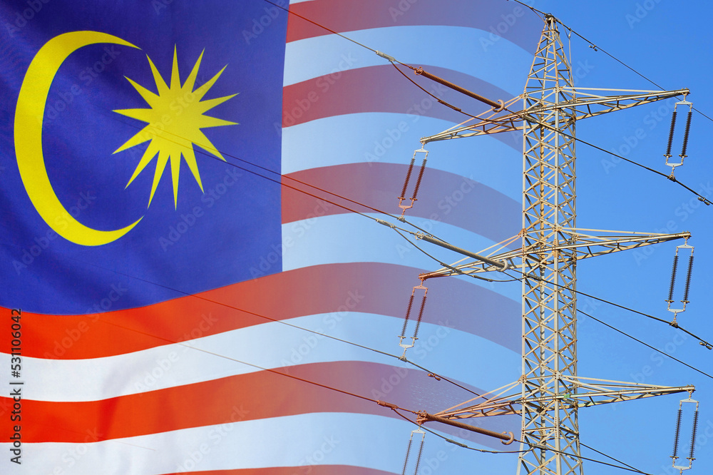 Malaysia flag on electric pole background. Power shortage and increased energy consumption in ...