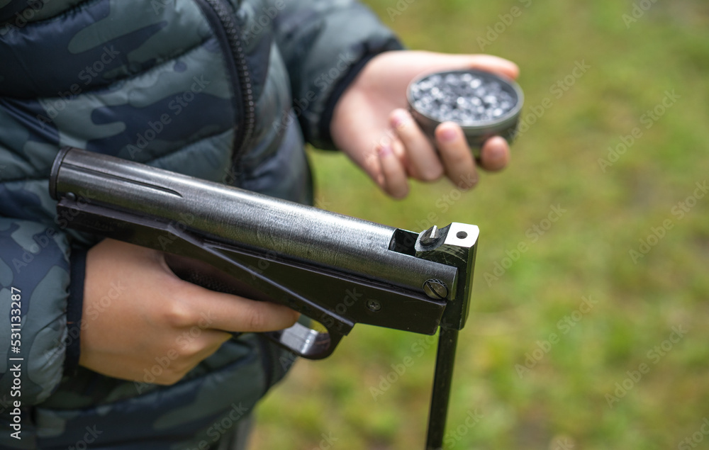 Shooting from an air pistol. Teaching a child to shoot. Shooting ...