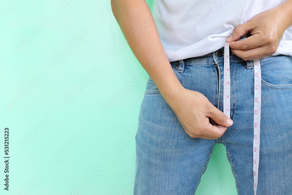 Size matters concept and penis size measurement. Young Asian man ...