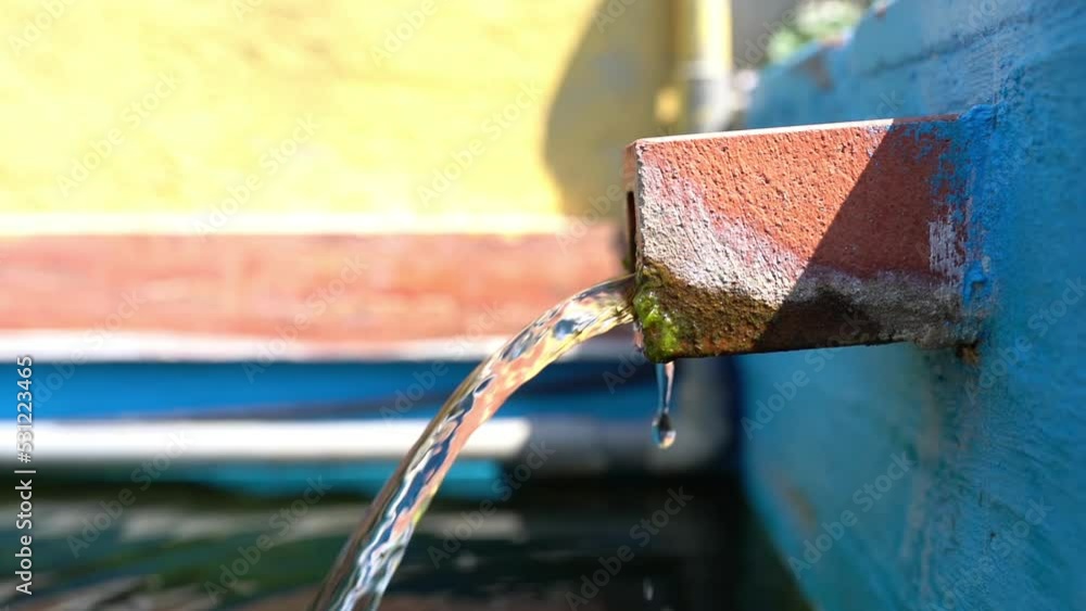 Flowing water from rusty pipe, stream of dirty water leaking from ...