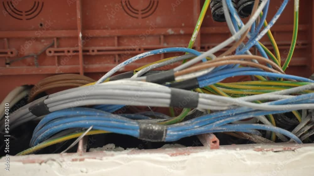 Close up shot of dirty colourful electrical cables installed inside the ...