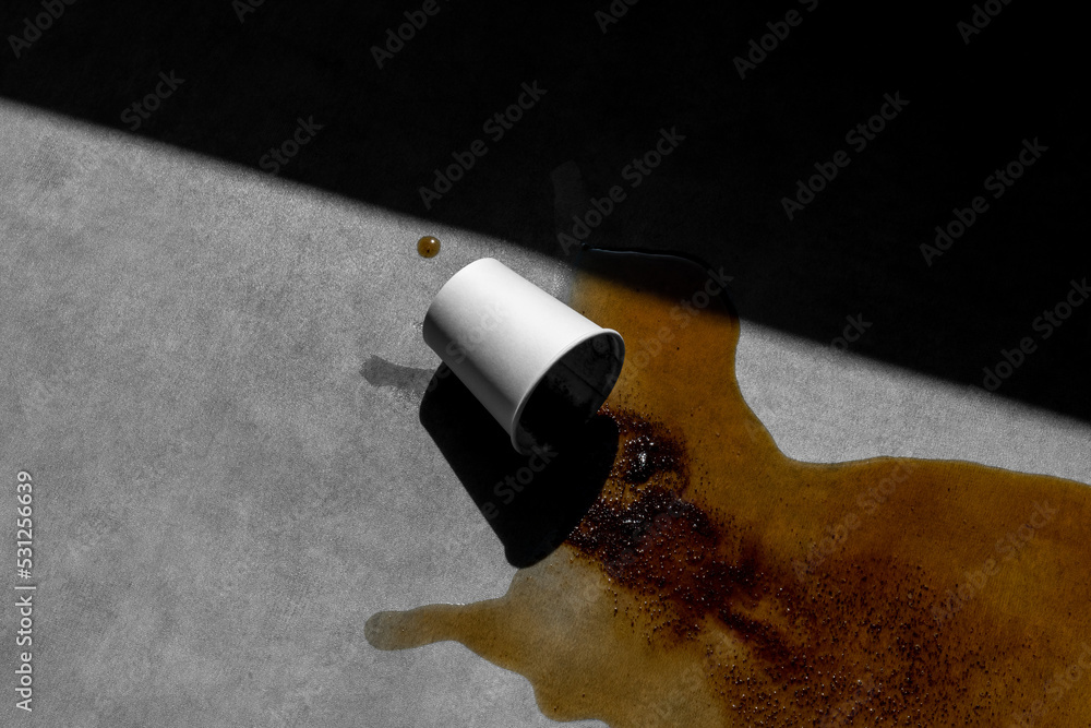 Spilled blank coffee paper cup on concrete background, with sharp ...