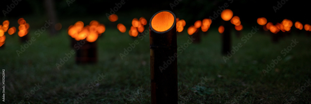 Hundreds of Japanese bamboo lanterns - candles in bamboo stands ...