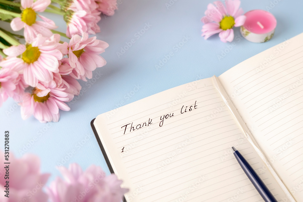 Handwritten words Thank you list in a personal diary on a light blue ...