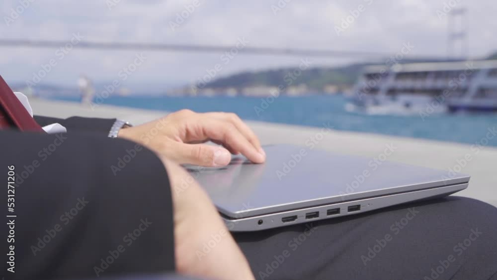 Thoughtful businessman opens his laptop and works. Slow motion. Close ...