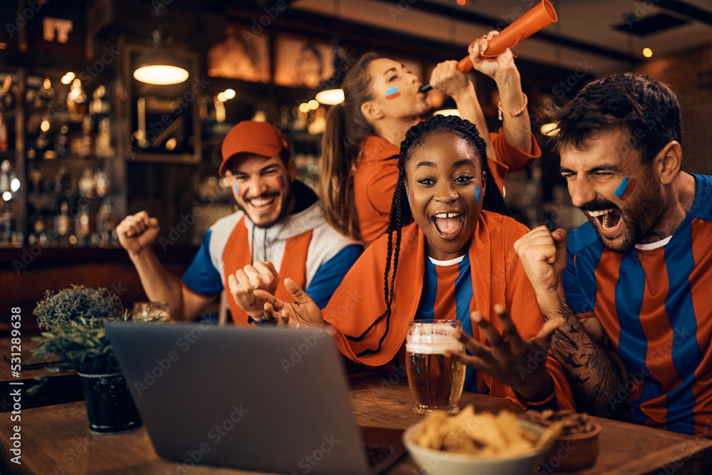Group of excited sports fans celebrating their favorite team's victory ...
