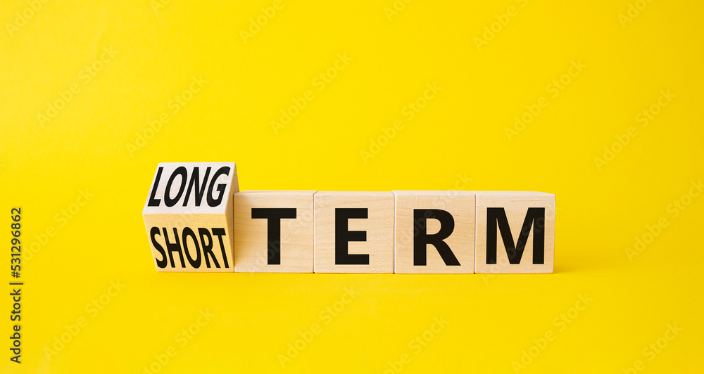 Long term vs Short Term symbol. Turned wooden cubes with words Long ...