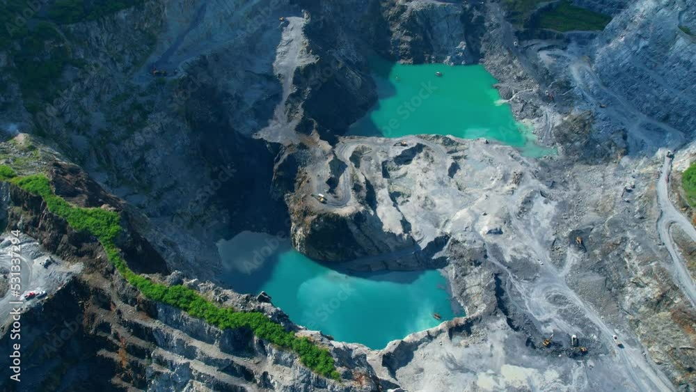 4K : Drones are flying over a large quarry, many machines are working ...