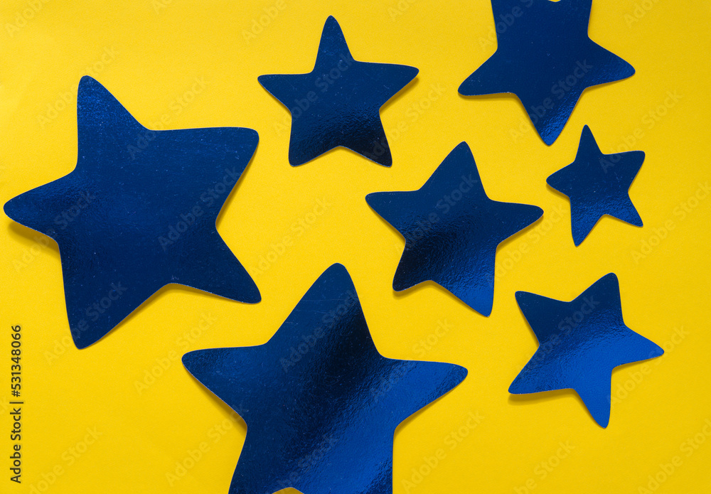 deep blue metallic stars on equally deep yellow paper background (with ...