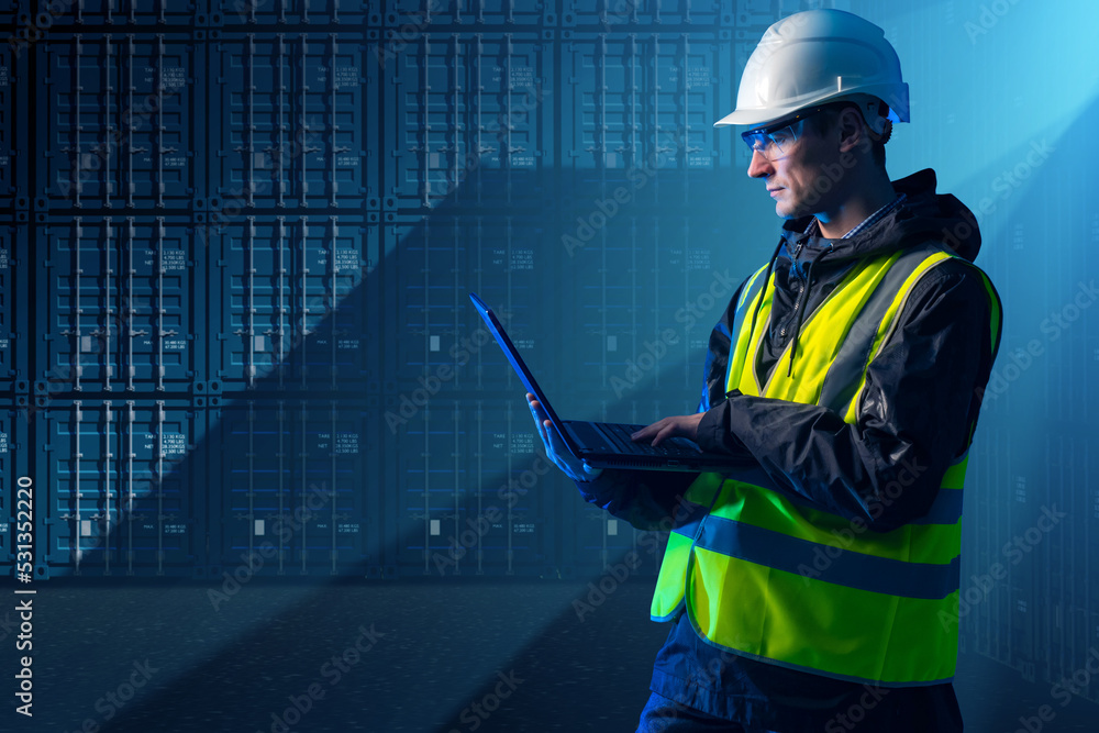 Logistic man. Guy with laptop in front of shipping containers ...