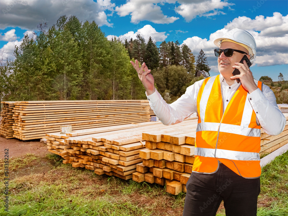 Logging business. Man lumber yard worker. Outdoor lumber warehouse ...