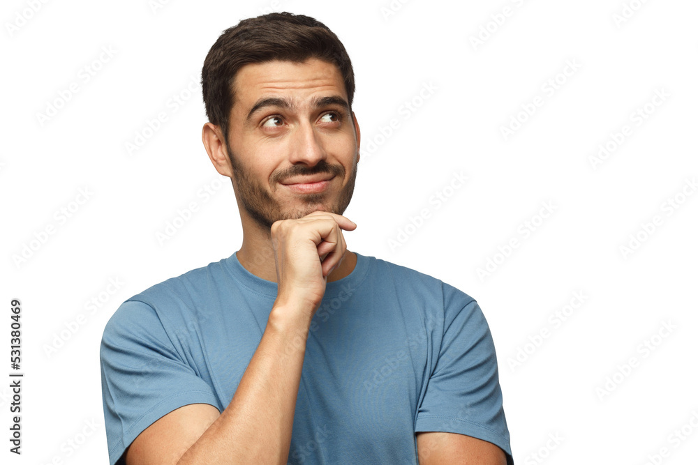 Portrait of young man in blue t-shirt with dreamy cheerful expression ...