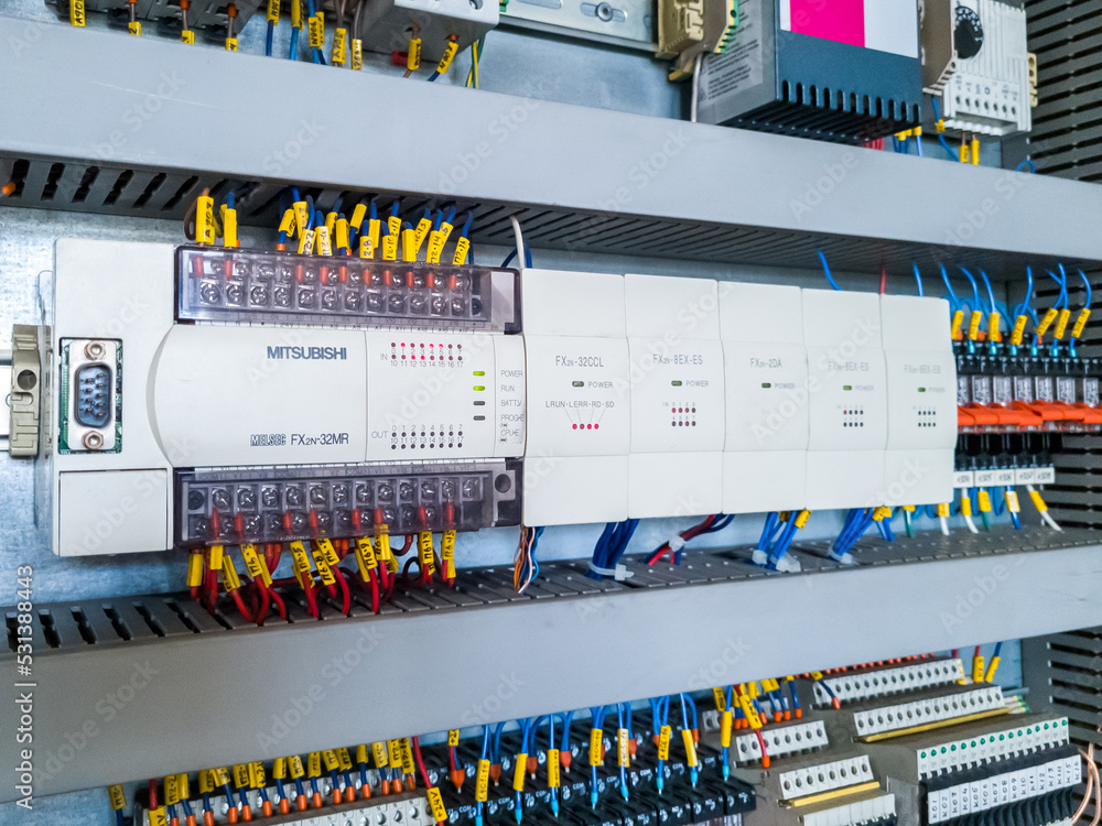 Mitsubishi PLC modules in a row in electrical cabinet of automation control system on industrial ...