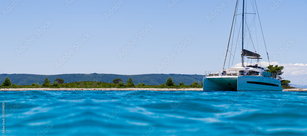 Catamaran sailing in ocean. paradise at sea. Blue sky and turquoise ...