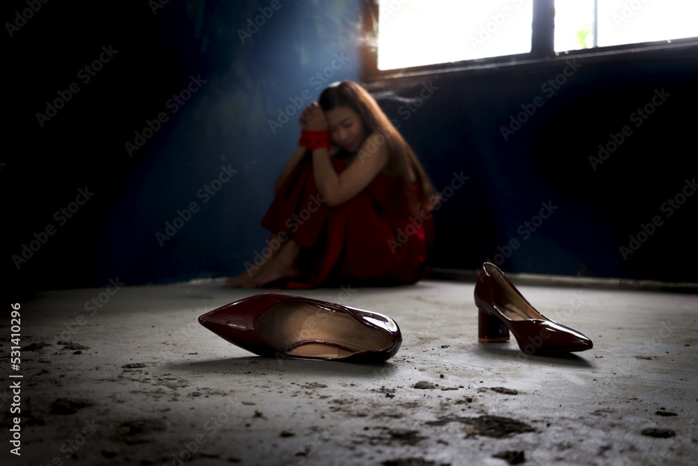 Red high heels with woman tied up with rope sitting on floor in the ...