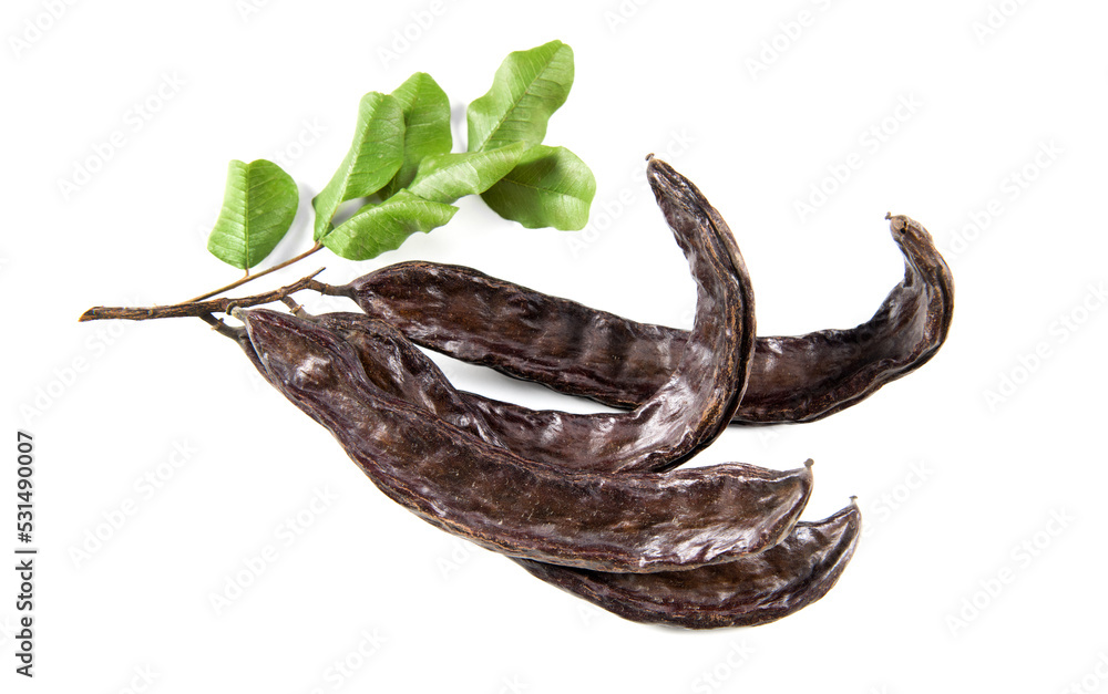Carob. Healthy organic sweet carob pods with seeds and leaves isolated ...