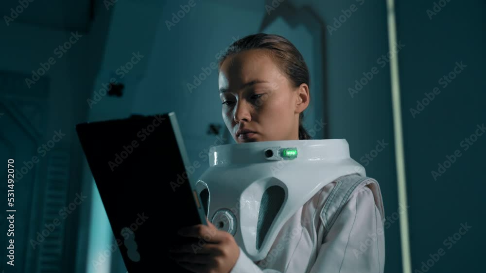 Tablet in the hands of a girl astronaut on board the space station ...
