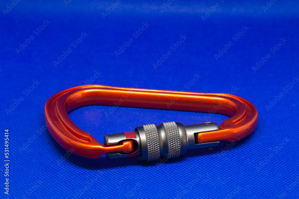 Carabiners for climbing on a blue background. Aluminium connectors for ...