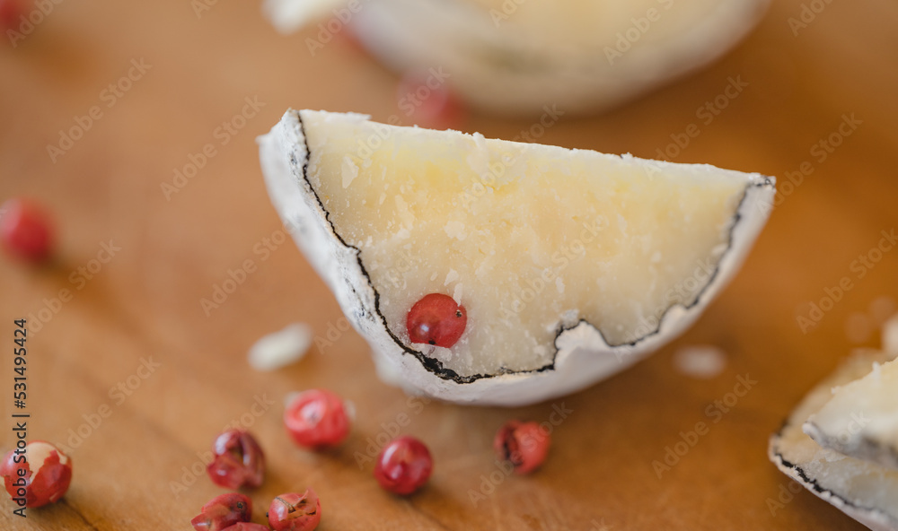A close view of belper knole balls with garlic and pink pepper in wood ...