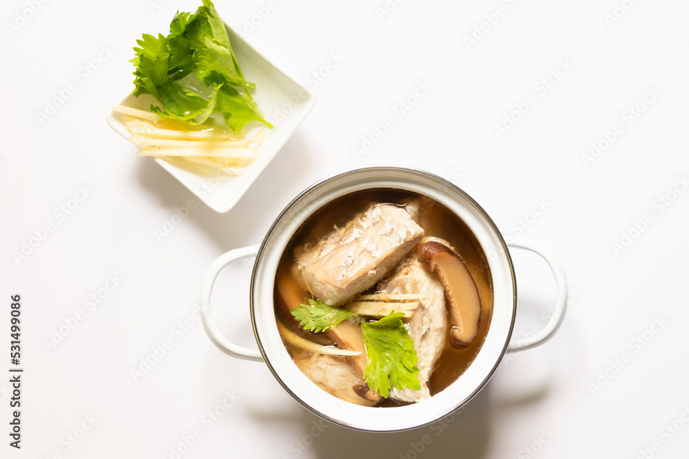 Pot of soup with sea bass fish and herb, healthy meal. Overview shot ...